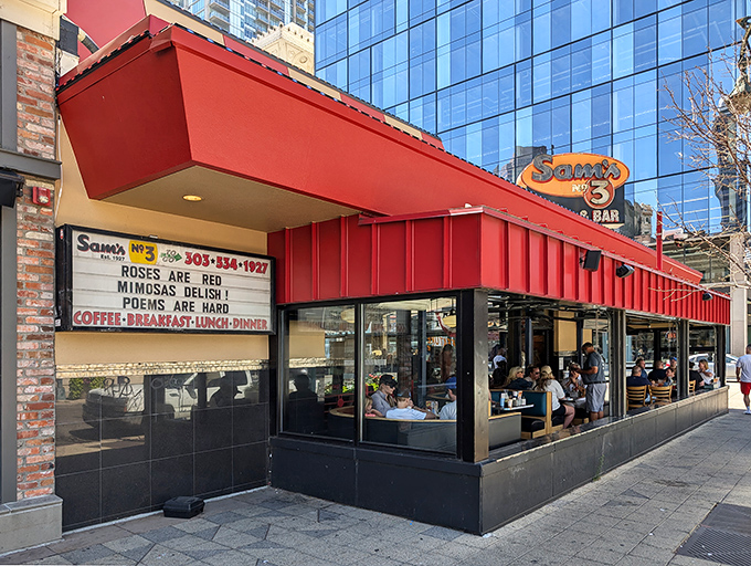Sam's No. 3 stands proudly with its iconic red awning, a beacon of comfort food amid downtown Denver's glass skyscrapers. Classic diner meets modern city.