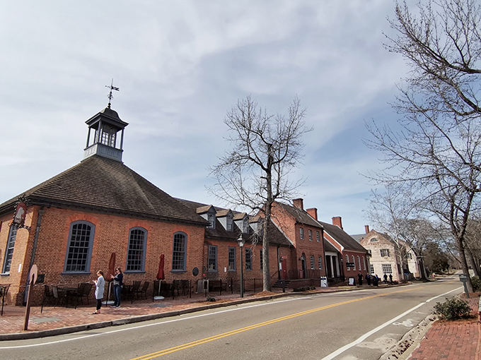 The octagonal cupola of Williamsburg's historic schoolhouse stands sentinel over brick buildings that have witnessed centuries of American history unfold beneath Virginia skies.