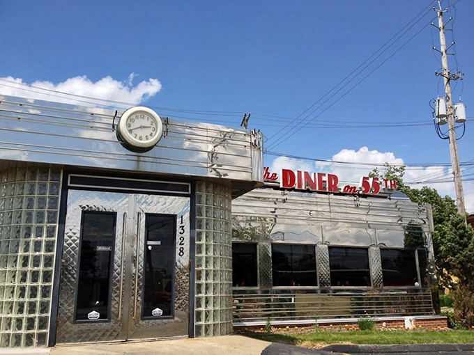 The gleaming stainless steel exterior of Diner on 55th stands like a time machine to the golden age of American dining. That vintage clock isn't just keeping time&mdash;it's preserving it.