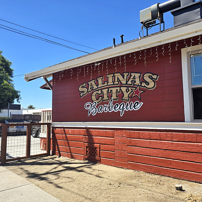 The little red house with the bright yellow door isn't trying to impress anyone&mdash;until you taste what's coming out of those smokers.