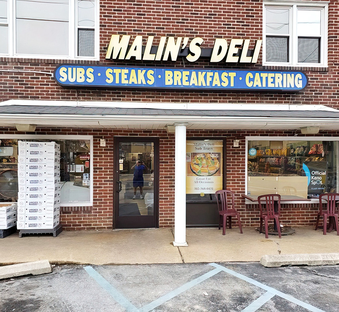 The brick façade of Malin's Deli stands as a beacon of sandwich salvation in Newark, promising subs, steaks, breakfast, and catering to hungry Delawareans.