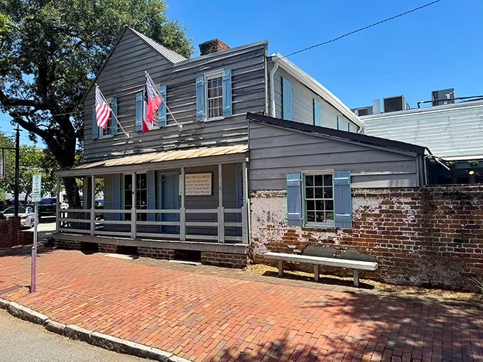 The weathered clapboard exterior and ancient oak tree whisper tales of seafaring rogues who once stumbled through these doors after months at sea.