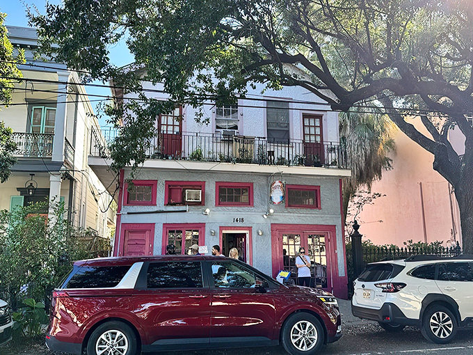 The pink-trimmed facade of Surrey's stands out on Magazine Street like a culinary beacon, promising breakfast treasures within those colorful walls.