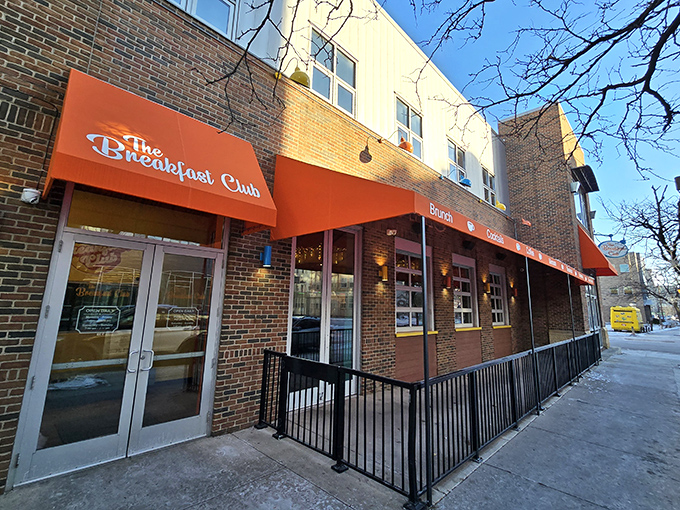 The vibrant red awning of The Breakfast Club MPLS beckons breakfast enthusiasts like a culinary lighthouse guiding hungry souls through Minneapolis mornings.