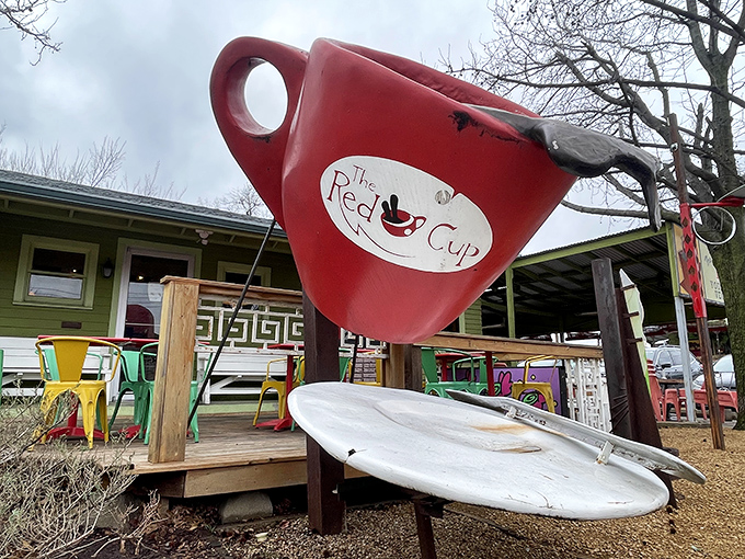 The giant red coffee cup sculpture stands like a caffeinated sentinel, welcoming hungry visitors to this quirky vegetarian oasis in Oklahoma City.