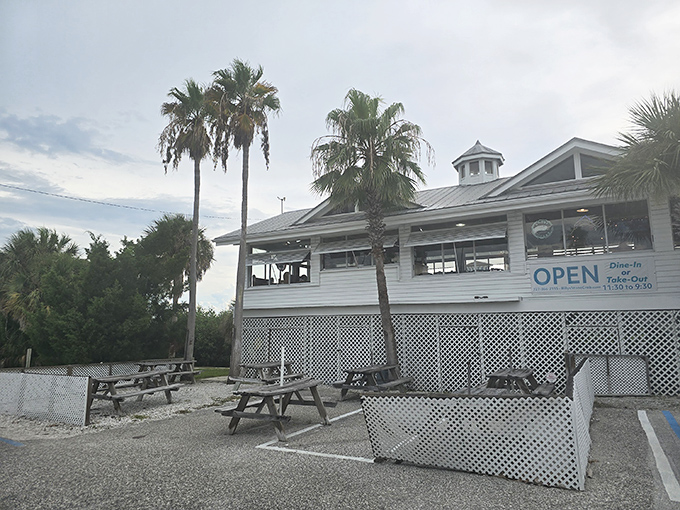 The iconic white lighthouse-topped entrance to Billy's Stone Crab beckons seafood lovers up those blue steps like a siren call to paradise.