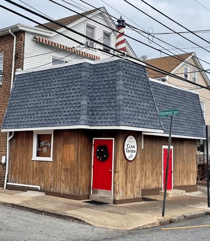 The unassuming exterior of Clam Tavern, with its distinctive red door and wooden facade, proves that culinary treasures often hide in plain sight.