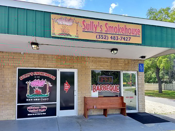 The unassuming exterior of Sully's Smokehouse proves once again that the best barbecue joints often hide behind the simplest facades. That wooden bench has heard many satisfied sighs.