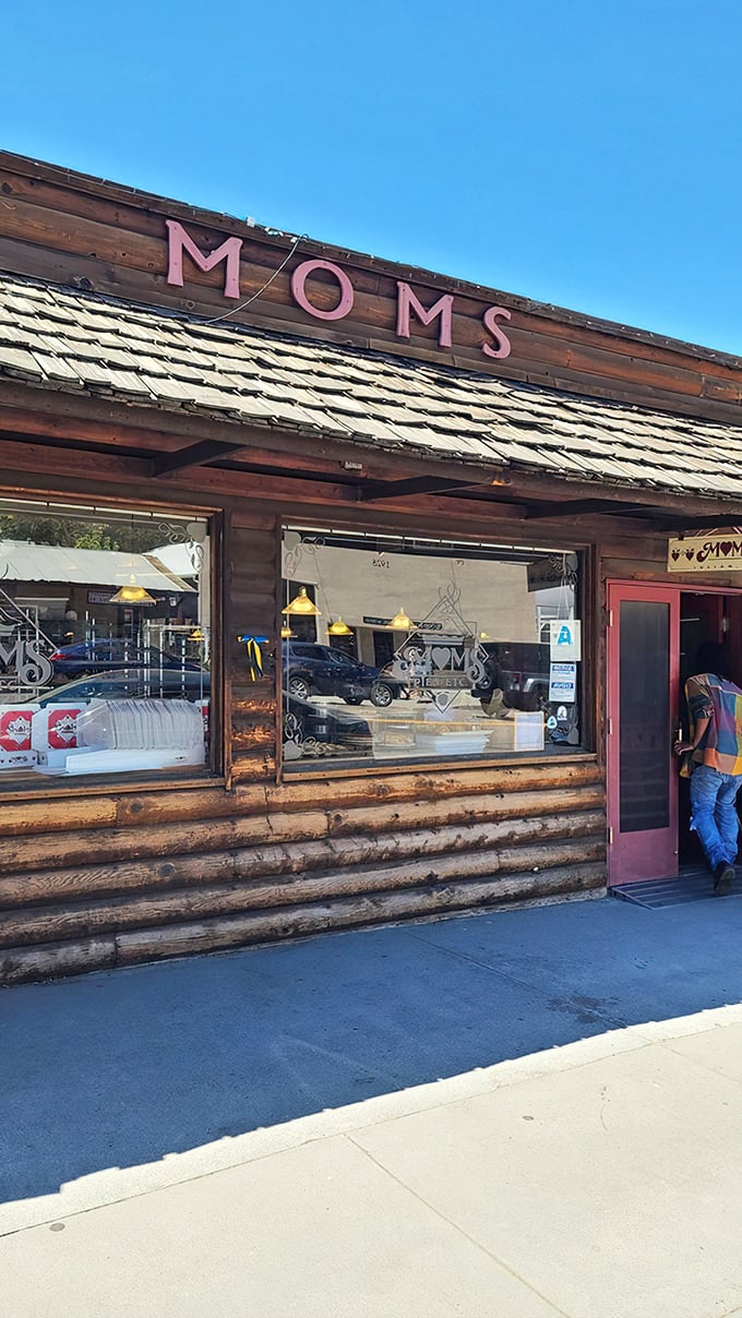 The rustic log cabin exterior with its signature red doors beckons pie lovers like a siren song for the sweet-toothed.