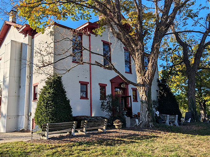 The white brick exterior with distinctive red trim stands as a testament to 1860s architecture, where lessons in arithmetic have given way to lessons in flavor.