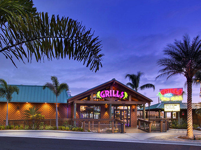 Florida's tropical paradise in architectural form. Palm trees stand guard as Grills' vibrant signage beckons hungry travelers into its wooden embrace.