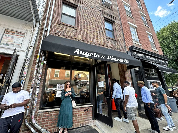 The unassuming storefront that houses culinary greatness. Angelo's Pizzeria's modest exterior belies the extraordinary food waiting inside, as evidenced by the perpetual line of devoted fans.