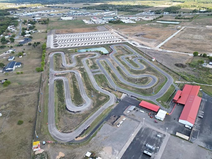 The half-mile track winds like a ribbon of asphalt promises, each curve secretly plotting against your ability to maintain dignity at high speeds.