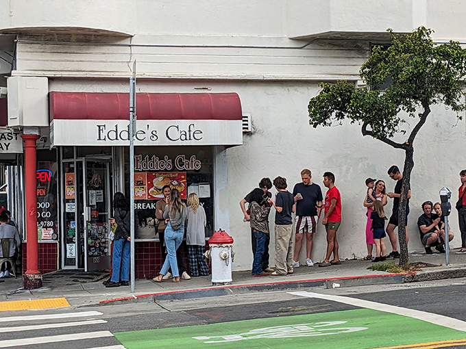 The sidewalk pilgrimage begins. Eddie's iconic storefront has been stopping San Franciscans in their tracks for generations, with a line that's practically a neighborhood ritual.