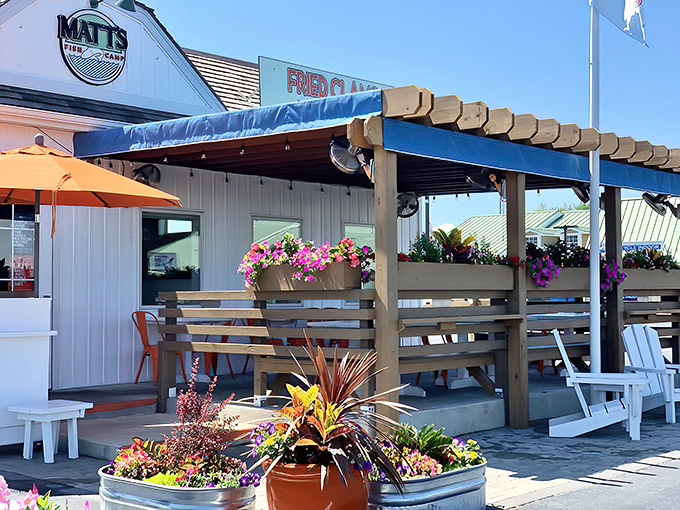 A coastal dream come true! Matt's Fish Camp's charming exterior with its blue accents, vibrant flower boxes, and inviting pergola practically whispers "come in, the seafood's fantastic."