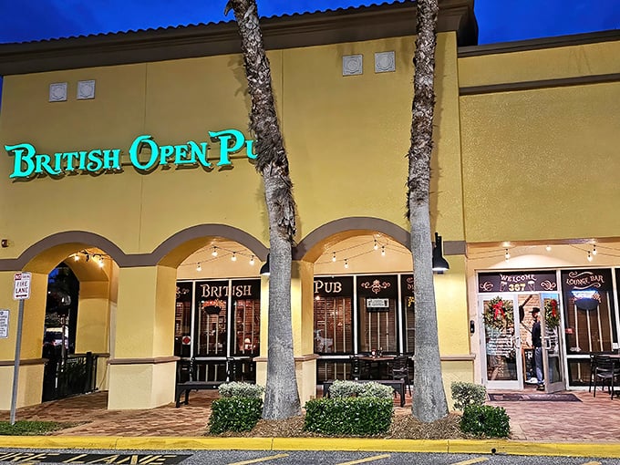 A slice of Britain basks in Florida sunshine. The British Open Pub's cheerful yellow exterior and teal signage create an inviting cultural crossroads where palm trees meet pub tradition.