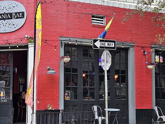 The vibrant red exterior of The Prytania Bar beckons like a culinary lighthouse in New Orleans' Garden District. Those black doors? They're portals to fish and chips paradise.