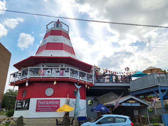 The iconic lighthouse exterior of Cooper's Seafood House stands like a beacon for hungry travelers. Nautical flags flutter above, promising seafood treasures within.