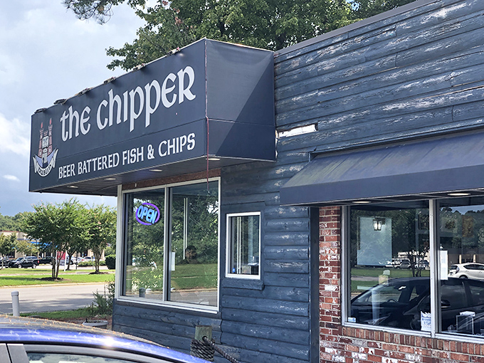 The blue wooden exterior of The Chipper stands like a portal to Britain, promising authentic beer-battered treasures within its unassuming walls.