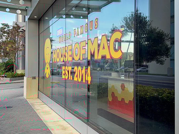 The neon glow of comfort food paradise beckons from Miami's urban landscape, promising cheesy dreams come true.