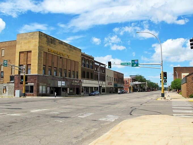 Albert Lea's historic downtown stretches beneath a perfect Minnesota blue sky, where brick buildings stand like sentinels of small-town affordability.