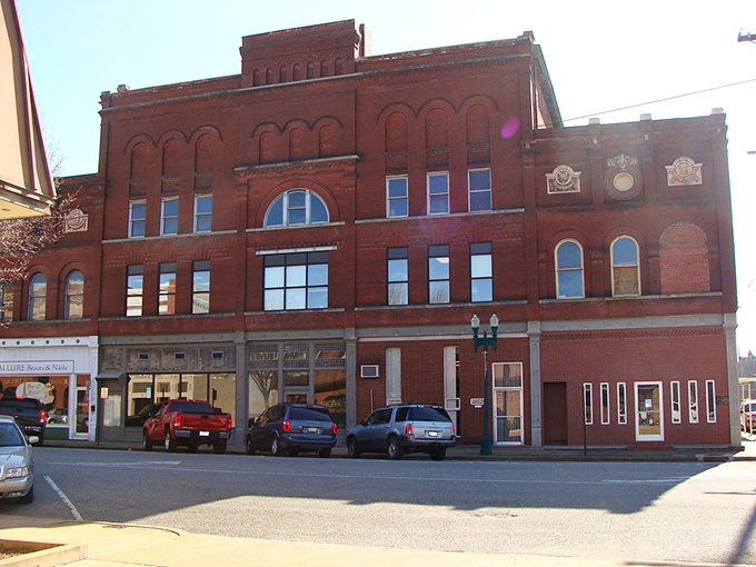 Paris's historic downtown square comes alive during market days, where locals gather under century-old shade trees for homemade treats and neighborly conversation. 