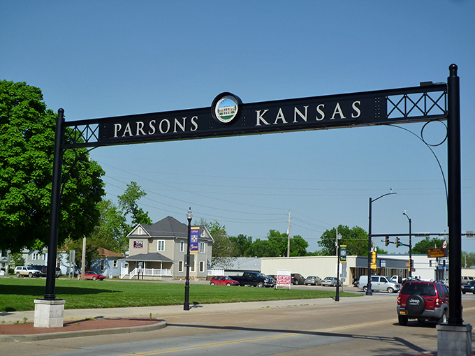 The iconic Parsons archway stands like a welcoming smile, inviting you into a town where your retirement dollars stretch further than your last diet plan.