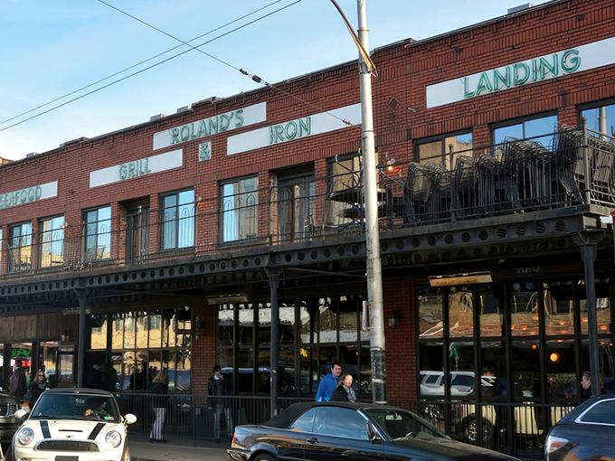 The iconic brick fa&ccedil;ade of Roland's stands proudly in Pittsburgh's Strip District, its neon-green signage promising oceanic delights in the heart of steel country.