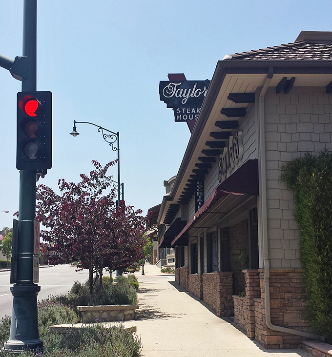 The iconic Taylor's sign beckons meat lovers like a lighthouse guiding hungry sailors home. Classic stone facade and vintage charm promise authentic steakhouse experience.