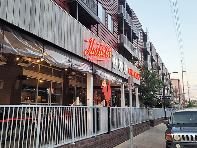 The iconic red rooster stands guard outside Hattie B's, a beacon of spicy salvation for heat-seekers across Alabama.