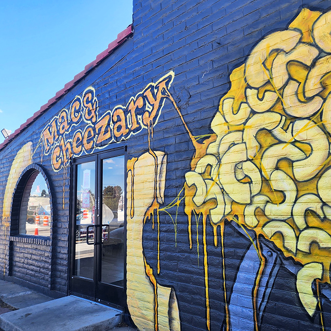 The blue building with dripping yellow cheese art isn't subtle about its mission. Like a cheese-themed Bat Signal calling comfort food lovers home.