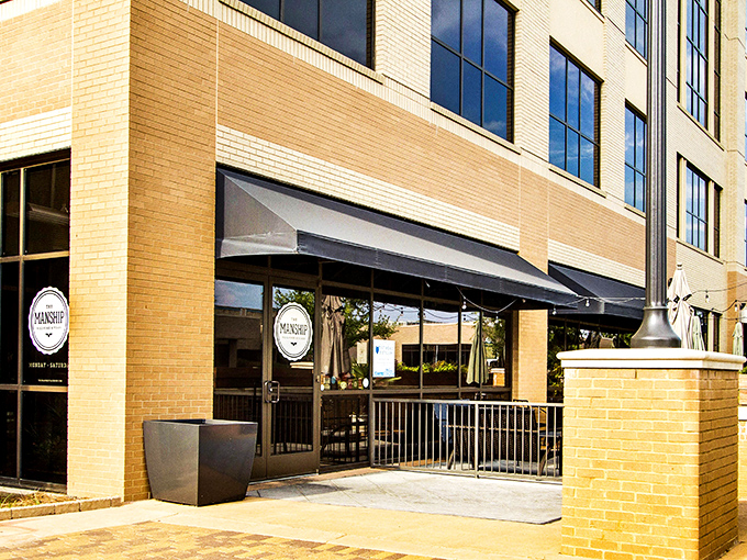The Manship's elegant brick exterior with vibrant red hedges offers a hint of the culinary magic happening inside this Jackson gem.