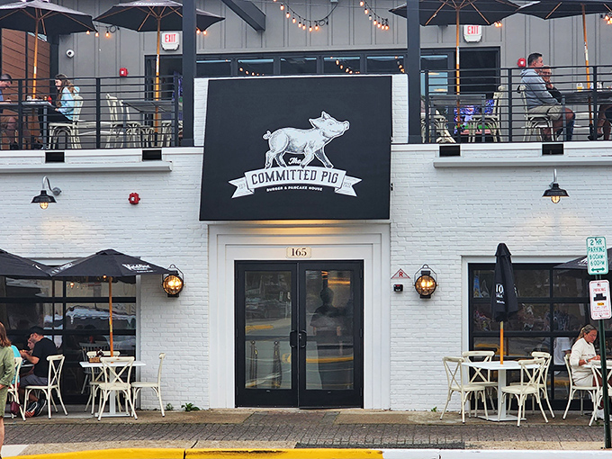 The Committed Pig's charming white exterior with rooftop dining is like finding the VIP section of Jersey Shore dining—complete with American flag and umbrellas for those who prefer shade with their indulgence.