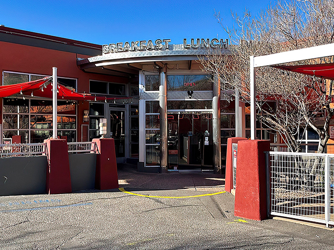 The iconic red exterior of Range Cafe beckons hungry travelers with its bold "BREAKFAST LUNCH DINNER" promise&mdash;a siren song for comfort food enthusiasts.