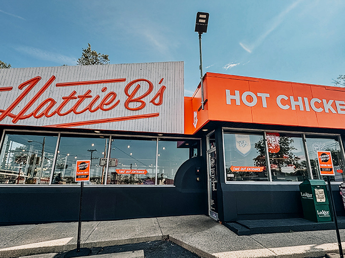The iconic red glow of Hattie B's beckons hungry pilgrims like a Nashville neon lighthouse. Even at dusk, the line forms for that crispy, spicy salvation. 