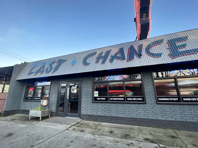 The neon-lit promise of "Slim's Last Chance" beckons like a honky-tonk mirage in Seattle's industrial landscape. Cold beer awaits inside this unassuming chili paradise.