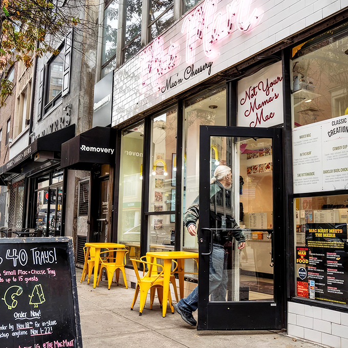 The pink and white storefront beckons like a cheesy lighthouse, with those sunny yellow chairs promising a comfort food adventure ahead.