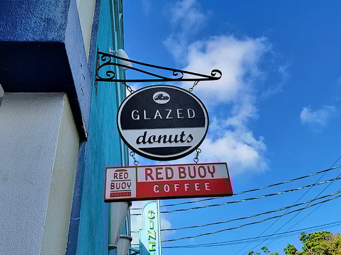 The iconic black and white Glazed Donuts sign beckons sweetly against Key West's blue sky, promising delicious treasures within.