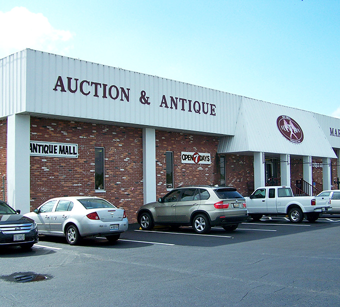 The unassuming exterior of Antique Marketplace hides a universe of treasures within, like finding a time portal disguised as a strip mall storefront.