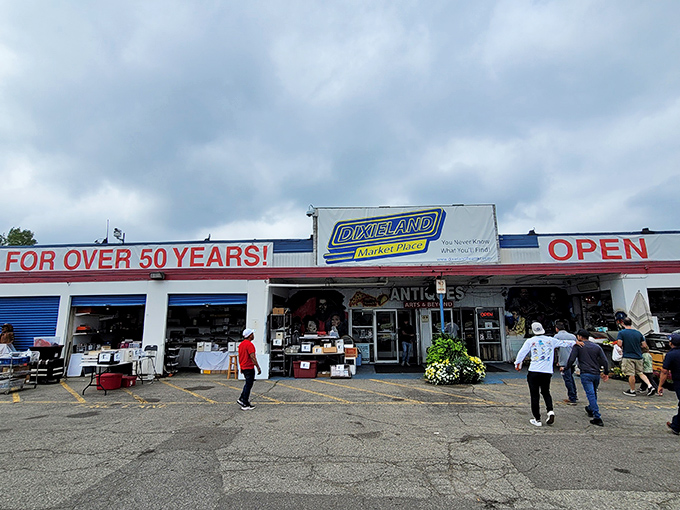 The weathered facade of Dixieland proudly announces "OPEN FOR OVER 50 YEARS!" like a badge of honor in a world of here-today-gone-tomorrow retail.