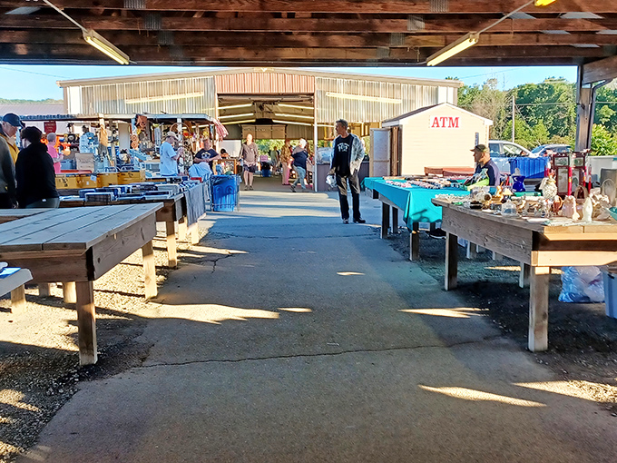 Treasure hunters navigate the covered pavilions at Jake's, where wooden tables await vendors and their wares like blank canvases ready for weekend masterpieces.