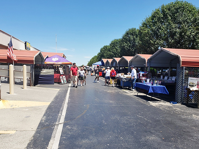 The outdoor vendor area buzzes with weekend warriors hunting treasures under Tennessee's blue skies. Every table holds someone's future conversation piece.