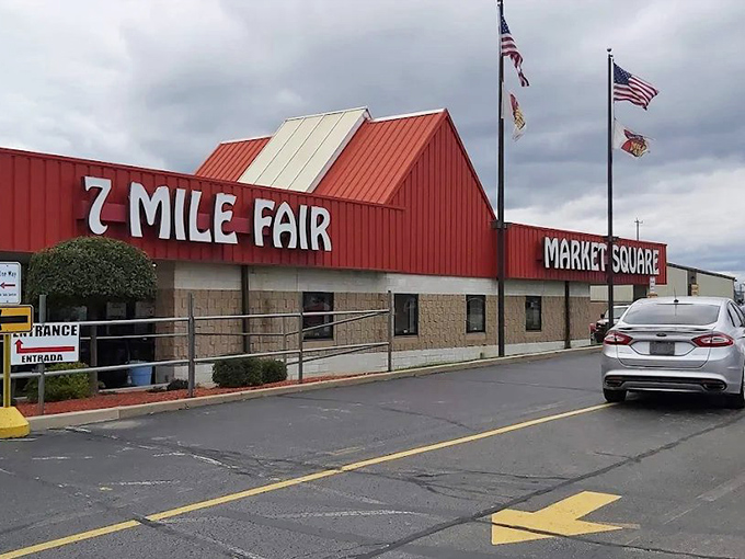 The iconic red-roofed entrance to 7 Mile Fair stands like a beacon for treasure hunters, promising adventures in bargain-hunting beneath Wisconsin skies.