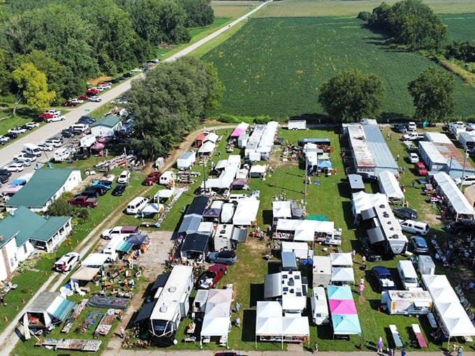 An aerial view reveals Sparks Flea Market's true scale&mdash;a sprawling treasure hunter's paradise nestled among Kansas farmland, where parking lots fill with hopeful bargain seekers.