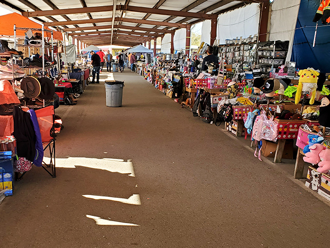 The red "FLEA MARKET" sign beckons like a siren call to bargain hunters. Treasure awaits under this bustling pavilion in Pass Christian.