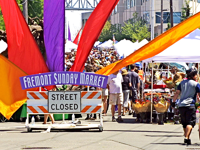 Colorful banners reach skyward, welcoming weekend treasure hunters to Seattle's ultimate urban safari. The hunt begins!