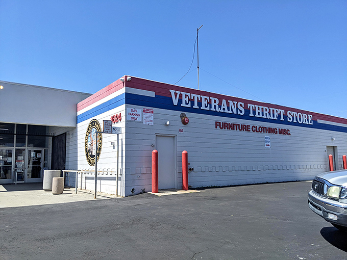 The iconic blue-tiled facade of Veterans Thrift Store stands like a treasure chest waiting to be opened, complete with California palm trees as sentinels.