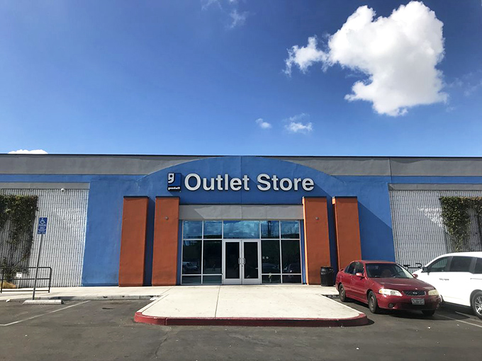 The blue-fronted Goodwill Southern California Community Enrichment Center stands ready to welcome bargain hunters beneath swaying palm trees, a treasure cave disguised as a retail store.