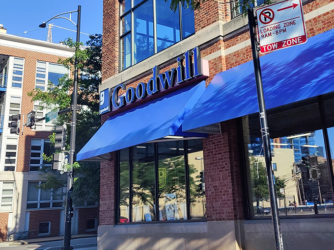 The iconic blue awnings of Goodwill beckon like a retail oasis in Chicago's urban landscape, promising treasures within those brick walls.