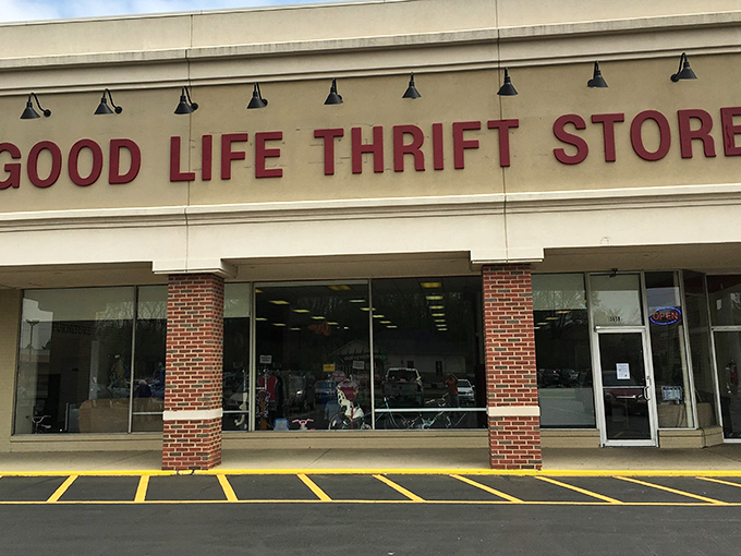 The red lettering against beige brick promises adventure within. Like a treasure map where X marks the bargain.
